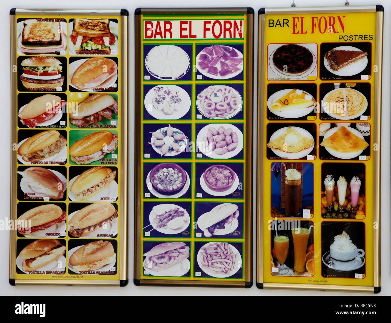 Range of dishes, menu with photos in the window of a tourist restaurant ...