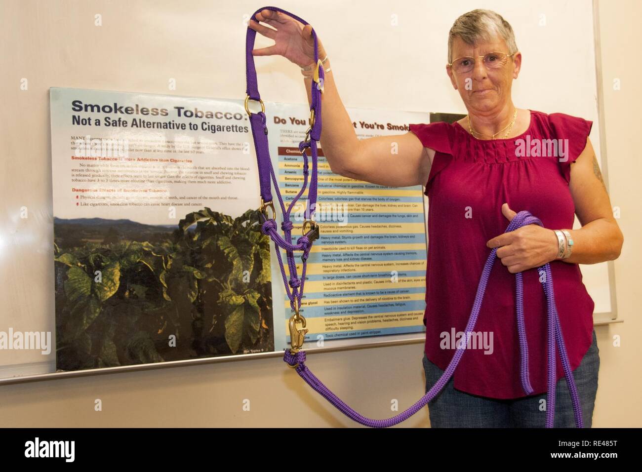 Ann Yates, 61-year-old military spouse and former smoker, holds up the ...