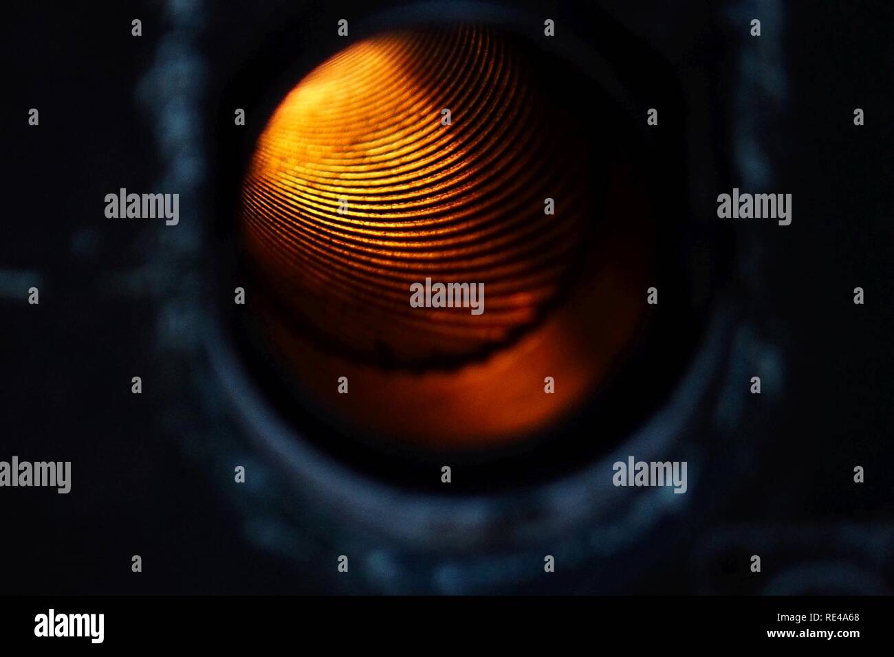 The setting sun casts light through the barrel of a M119A2 105mm ...