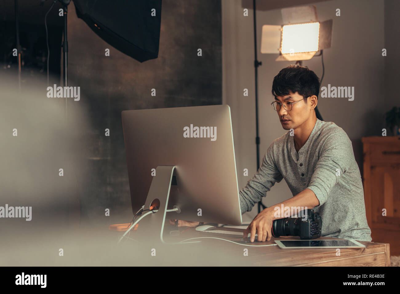 Photographer transferring photos on computer from camera after the ...