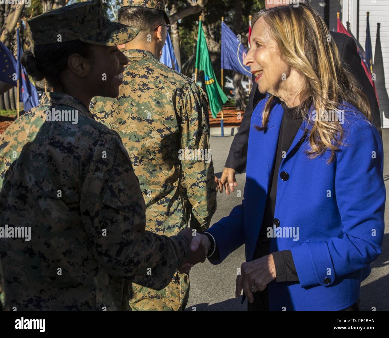 Maxine Russell receives a handshake from a Marine serving with the 1st ...