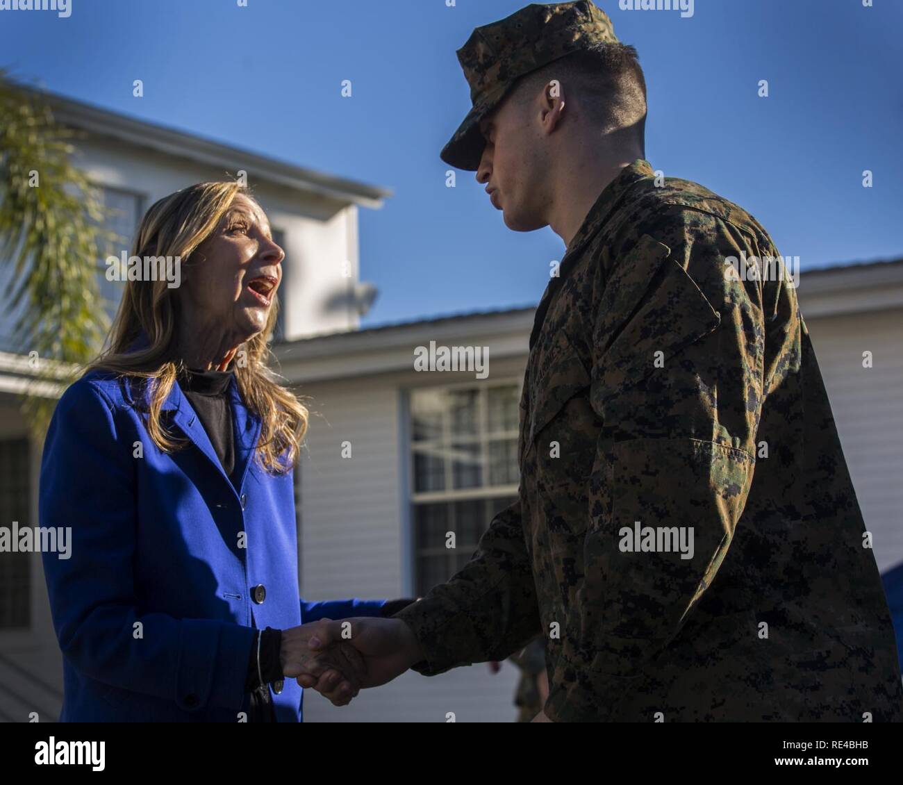 Maxine Russell receives a handshake from a Marine serving with the 1st ...