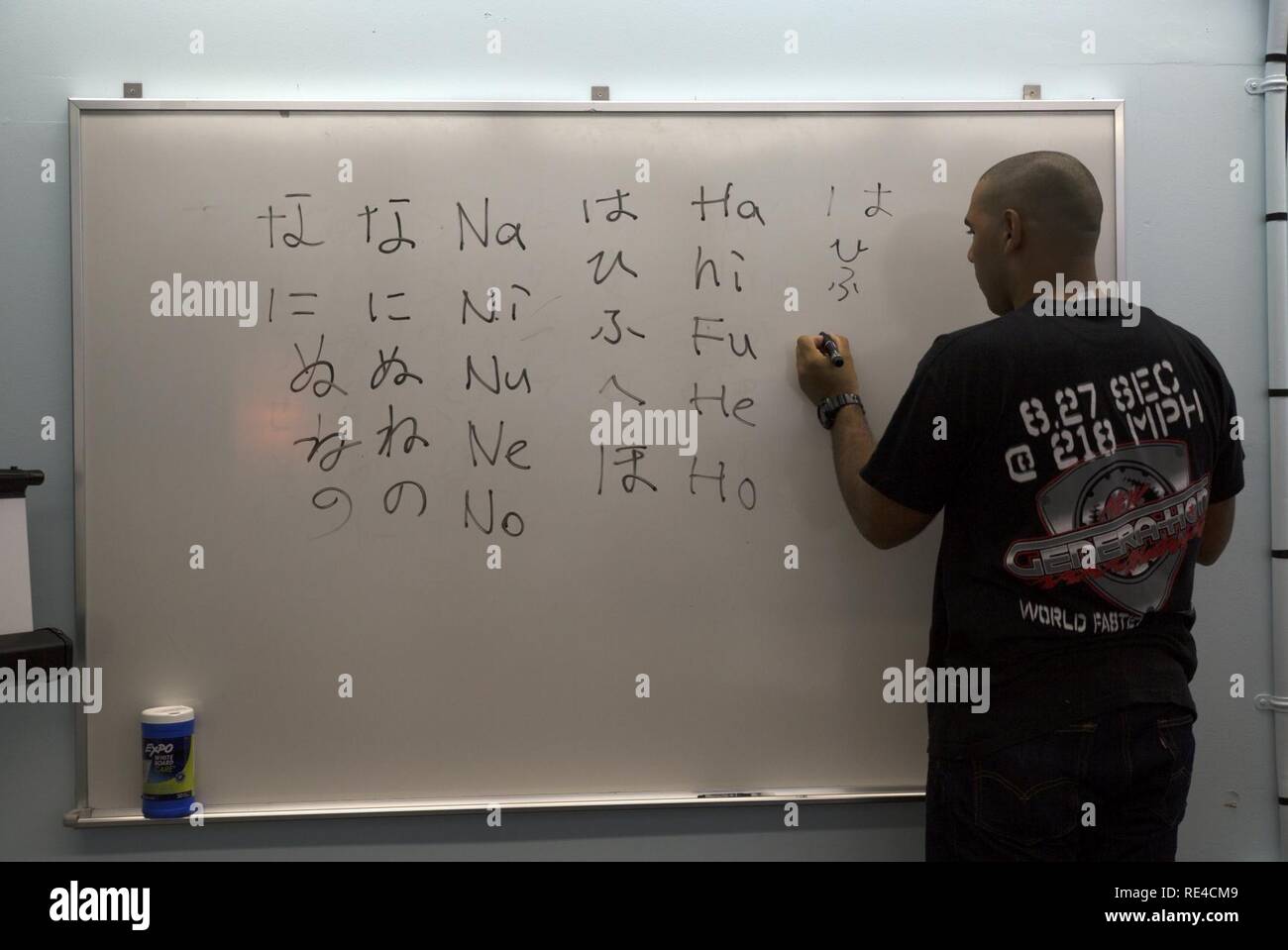 A student practices writing Japanese hiragana characters on a ...
