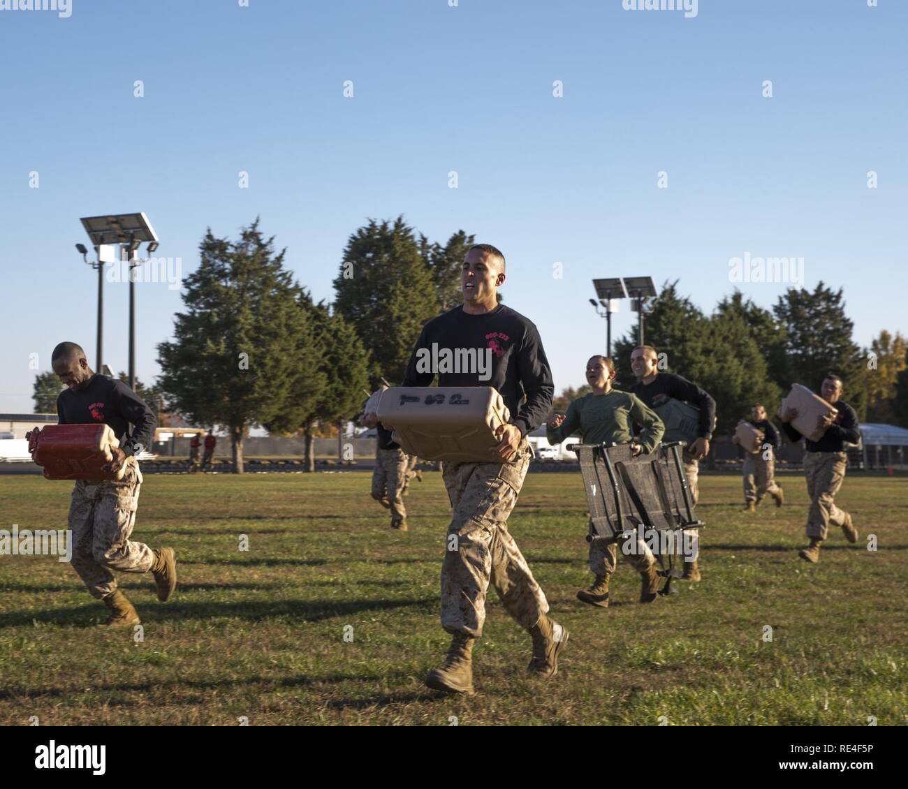 U.S. Marines with the Officer Candidate School (OCS) run with water ...