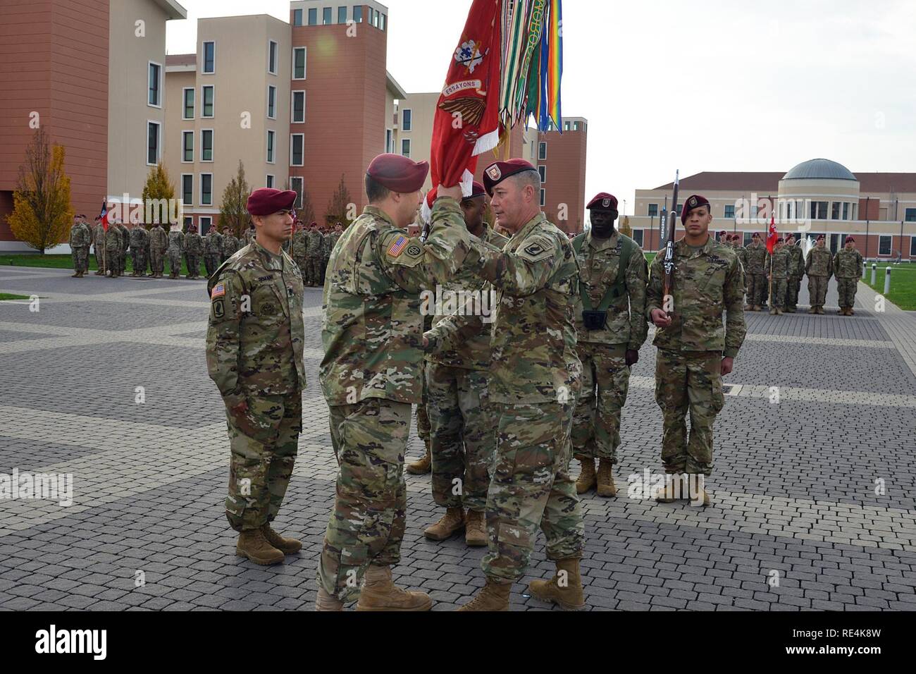 Command Sgt. Maj. Travis C. Crow, right, passes the flag to Lt. Col ...