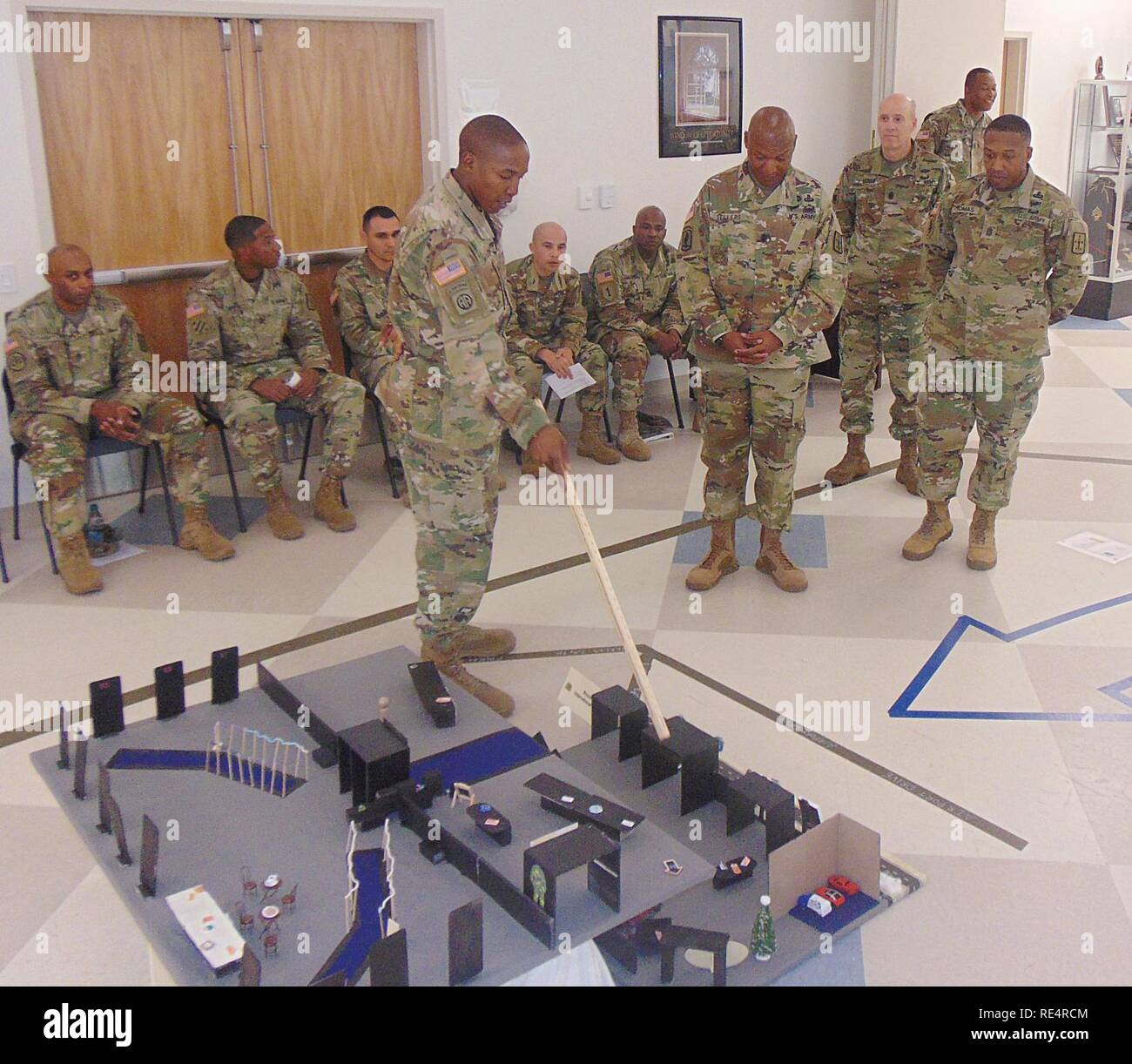 A noncommissioned officer briefs Command Sgt. Maj. Jimmy Sellers ...
