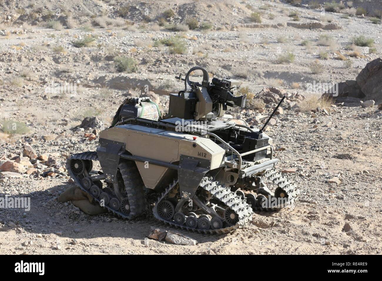 A Weaponized Multipurpose Unmanned Tactical Transport (W-MUTT) provides ...