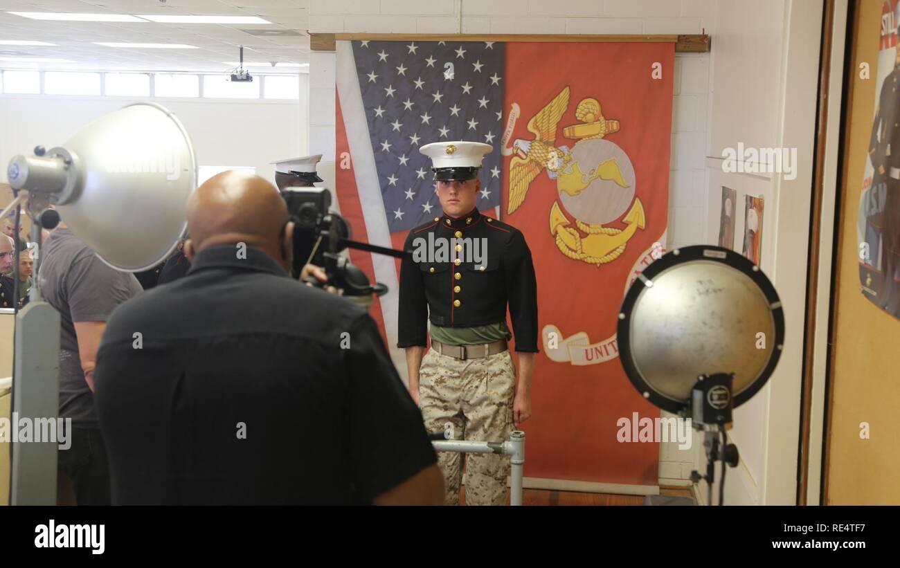 Christopher Deans, a Recruit Photographer, takes an official photo of a ...