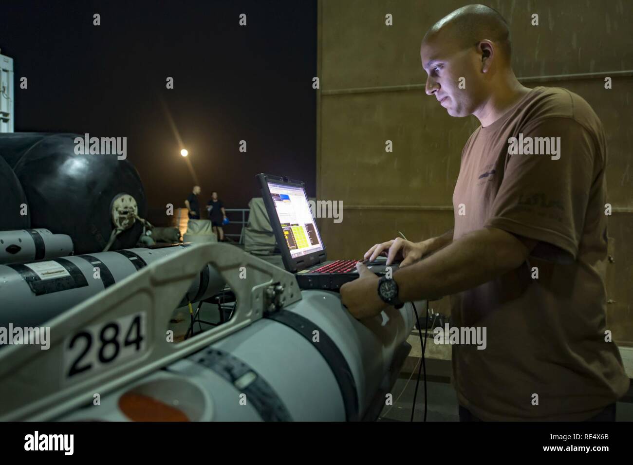 Petty Officer 3rd Class Navin Huddle programs an Mk18 Mod 2 unmanned ...