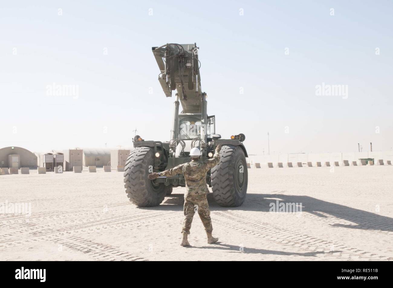 U.S. Army Master Sgt. Edgar Ponce guides Spc. Agnes Torres, both with ...