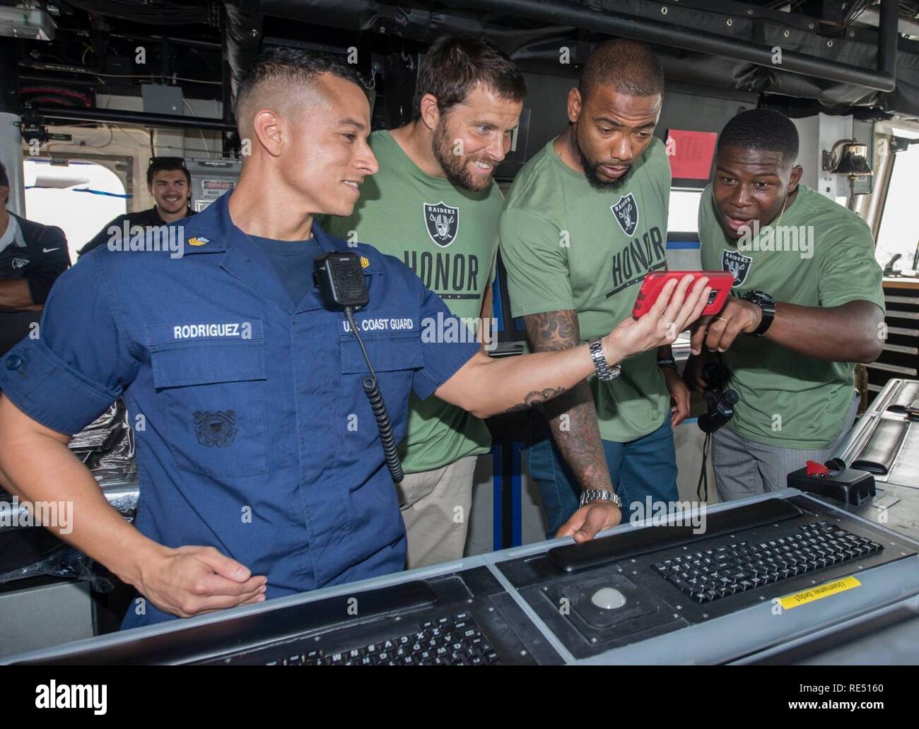 A Coast Guard member shows a video of underway operations to several ...