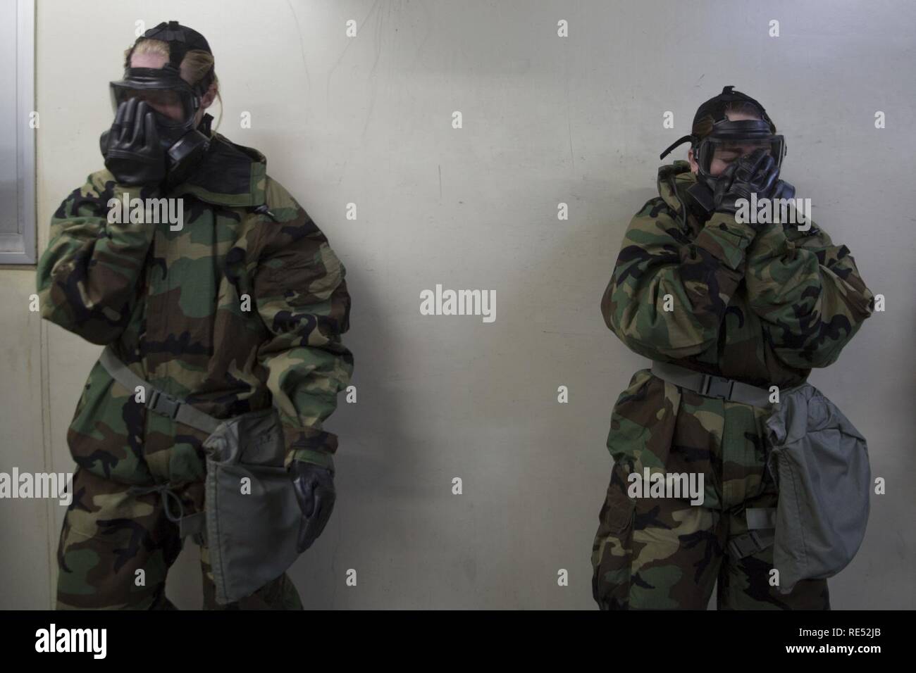 Marines with the 31st Marine Expeditionary clear their protective masks ...