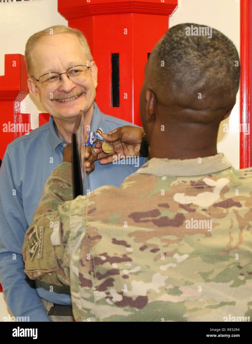 Col. Jason E. Kelly, Afghanistan District Commanding Officer pins the ...