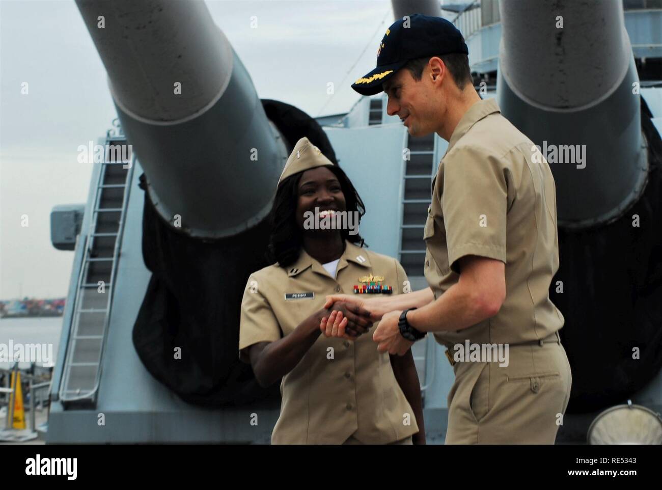 Lt.j.g. Latina Perry (left), assigned to the USS Tortuga (LSD 46), is ...