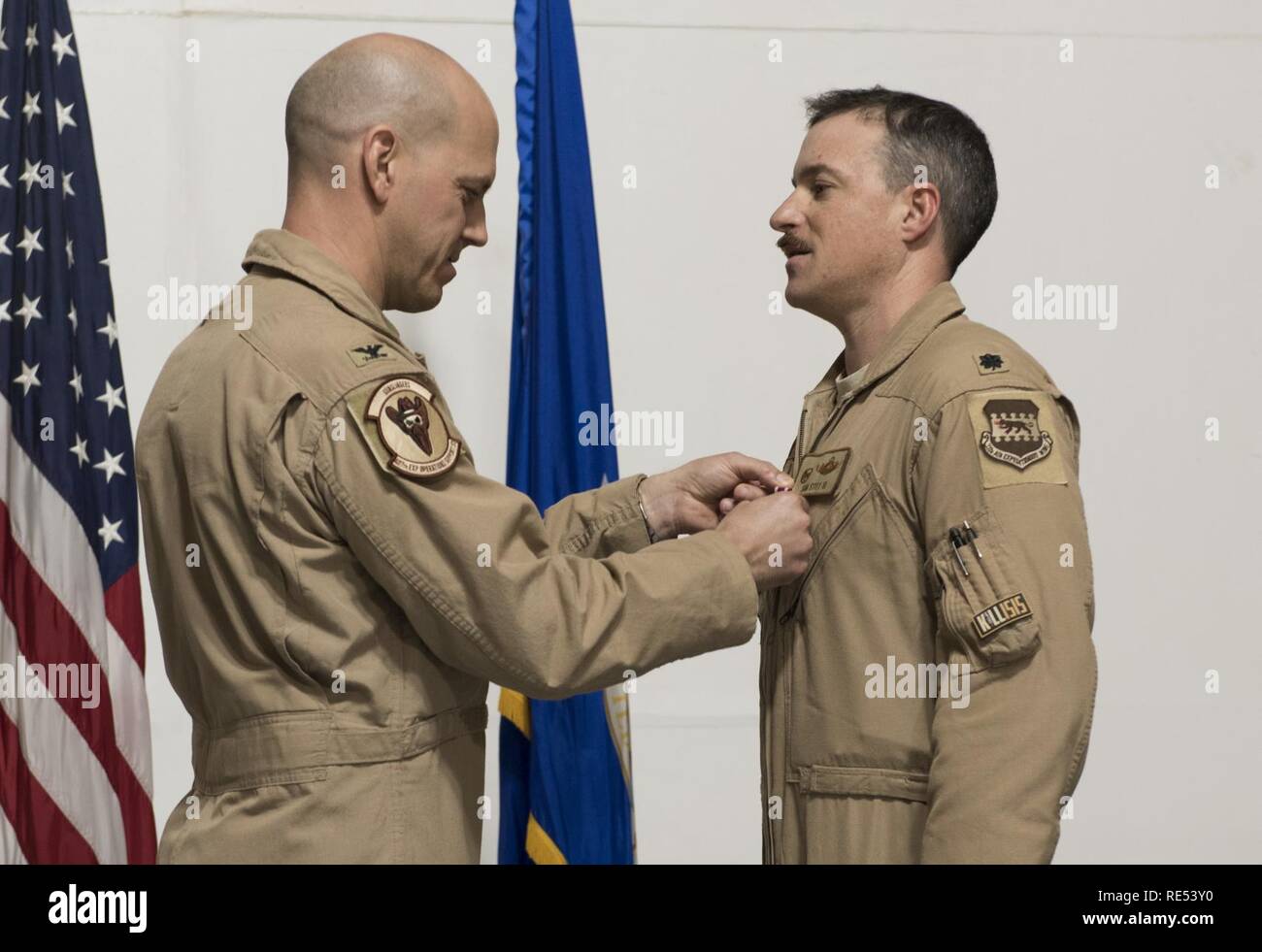 Col. Scott Gibson, 407th Air Expeditionary Group commander, awards the ...