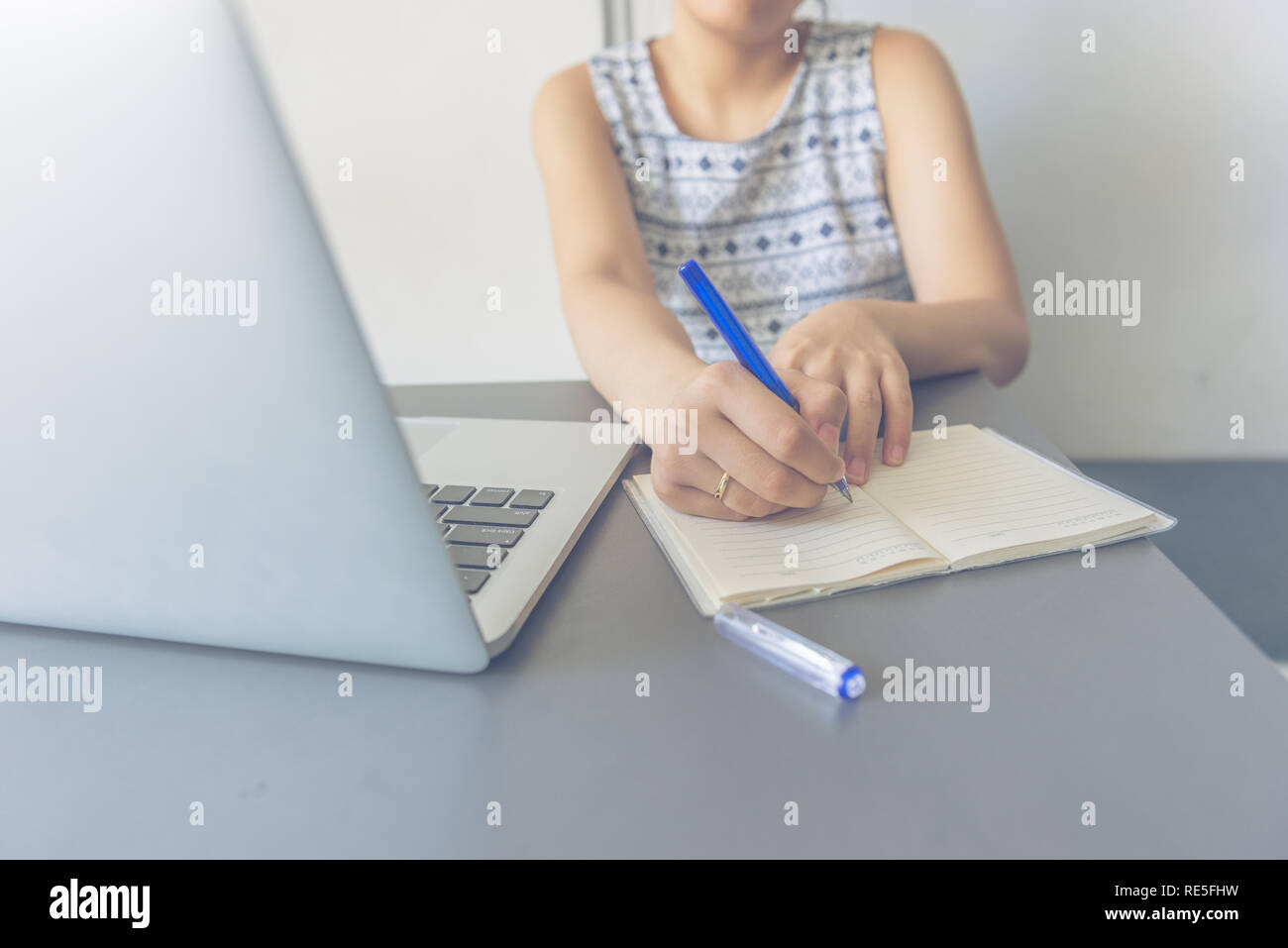 Asian teen girl writing library hi-res stock photography and images - Alamy