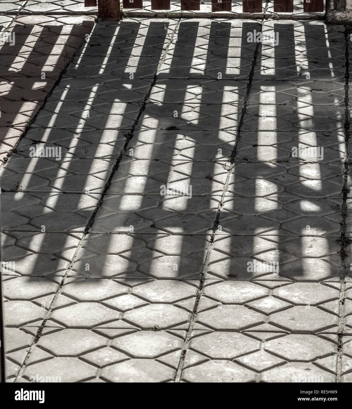 The shadow of a wooden rural fence on the pavement Stock Photo - Alamy