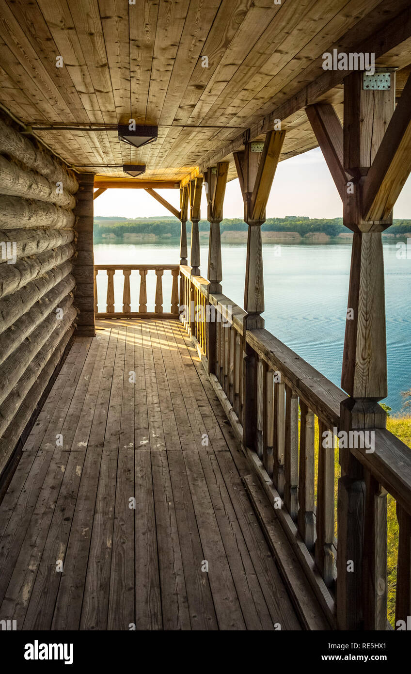 The veranda of a wooden house with a beautiful view of the river Stock ...