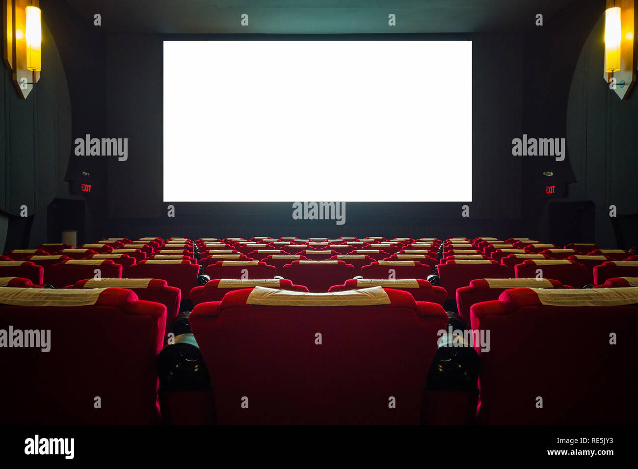 Cinema hall with red seat and wide white screen Stock Photo - Alamy