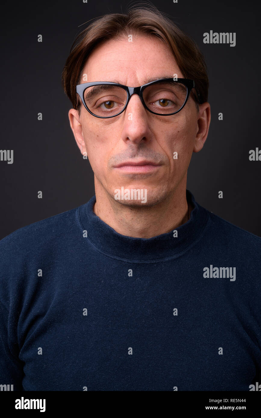 Face of mature handsome Italian man against gray background Stock Photo ...