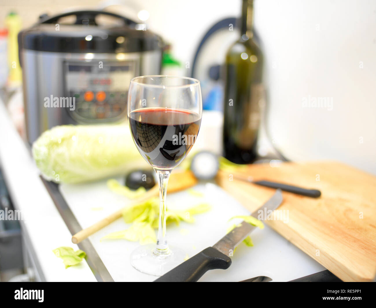 Glass of red wine on a kitchen table, drinking while cooking Stock ...