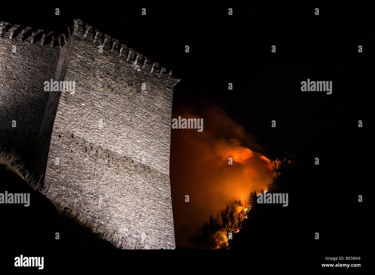 The old medieval castle of Mesocco and forest on fire Stock Photo - Alamy