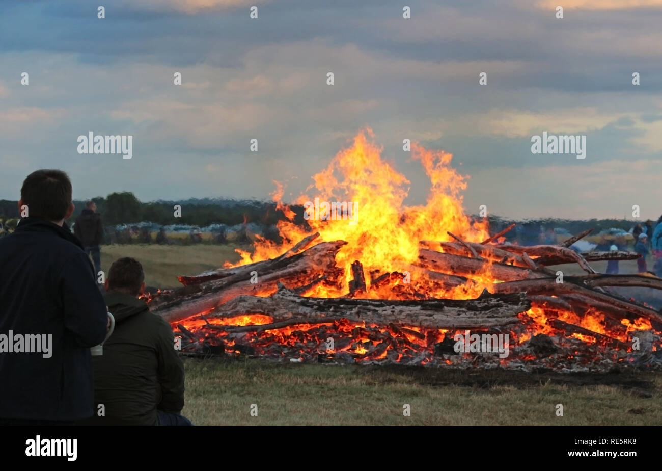 rear view of people watching a large bonfire Stock Photo - Alamy