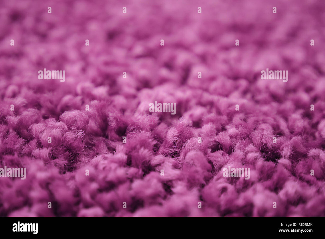 Closeup surface of soft carpet of amazing pink color, selective focus ...
