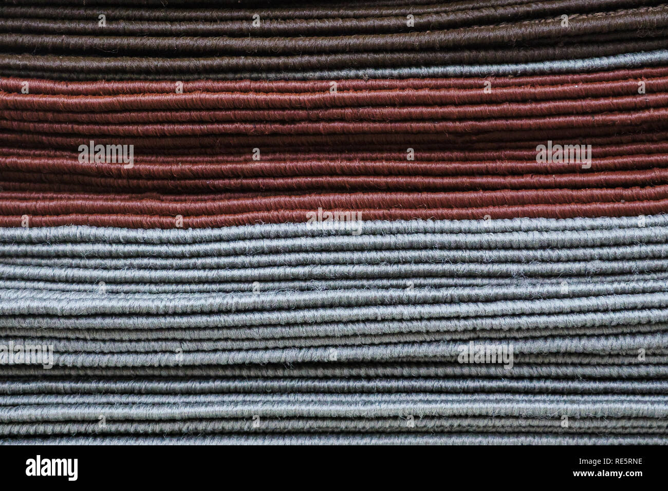 Assorted soft mats lying in one pile in modern shop, background Stock ...