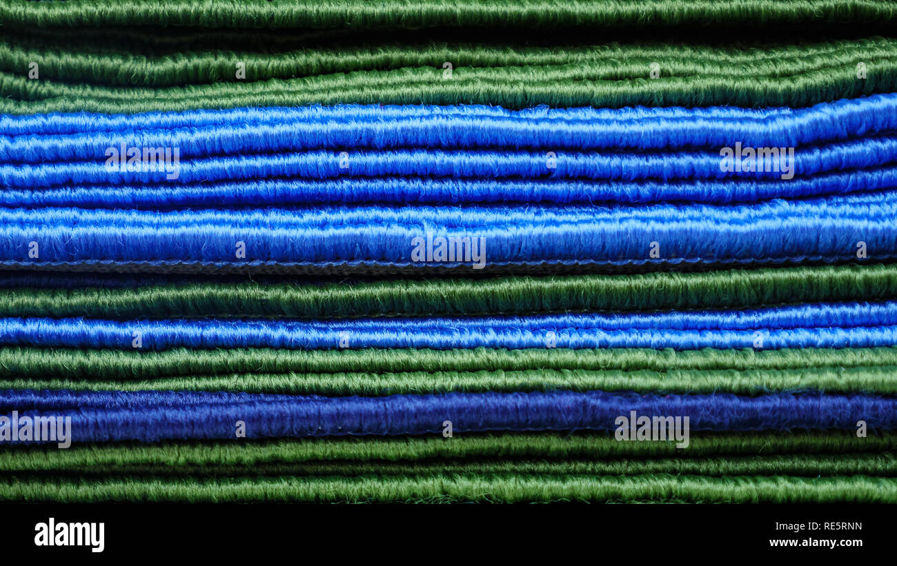 multi colored soft mats lying in one pile in modern shop Stock Photo ...