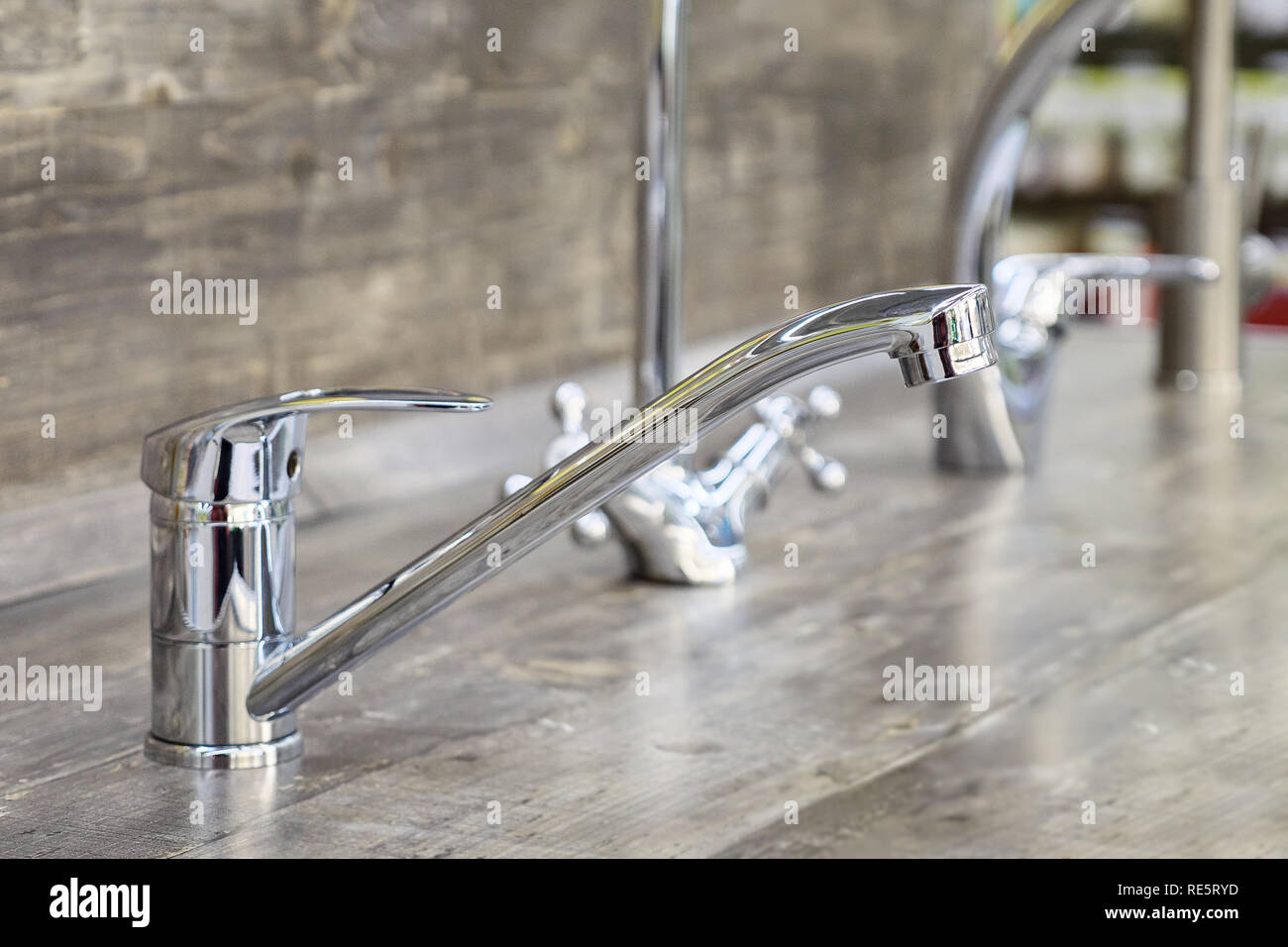 Water taps standing on shelf in shop Stock Photo - Alamy
