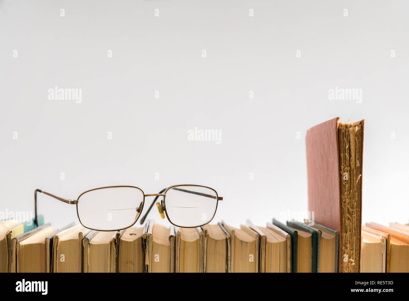 Open book, hardback hard cover colourful books with reading glasses on ...