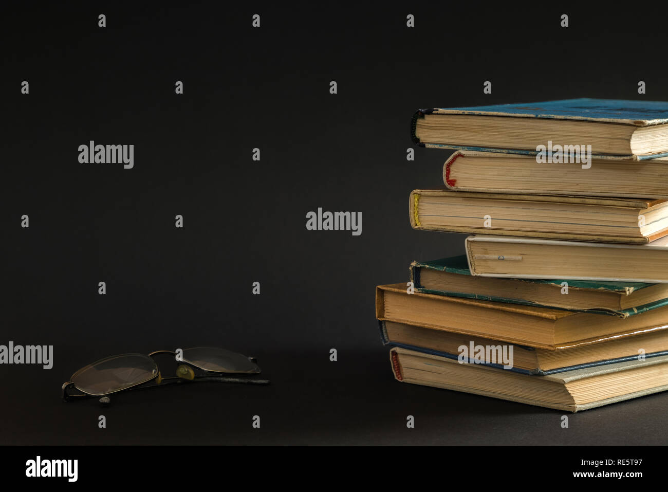 Open book, hardback hard cover colourful books with reading glasses on ...