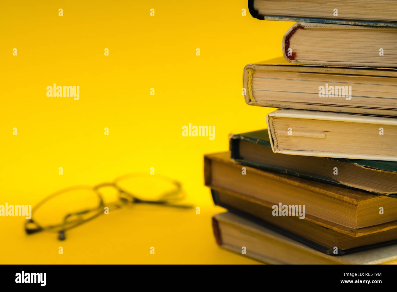 Open book, hardback hard cover colourful books with reading glasses on ...