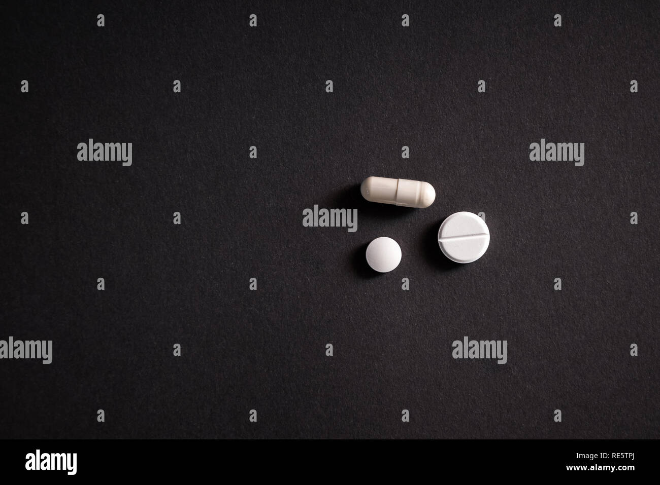Medicine pills or capsules on black background. Drug prescription for ...