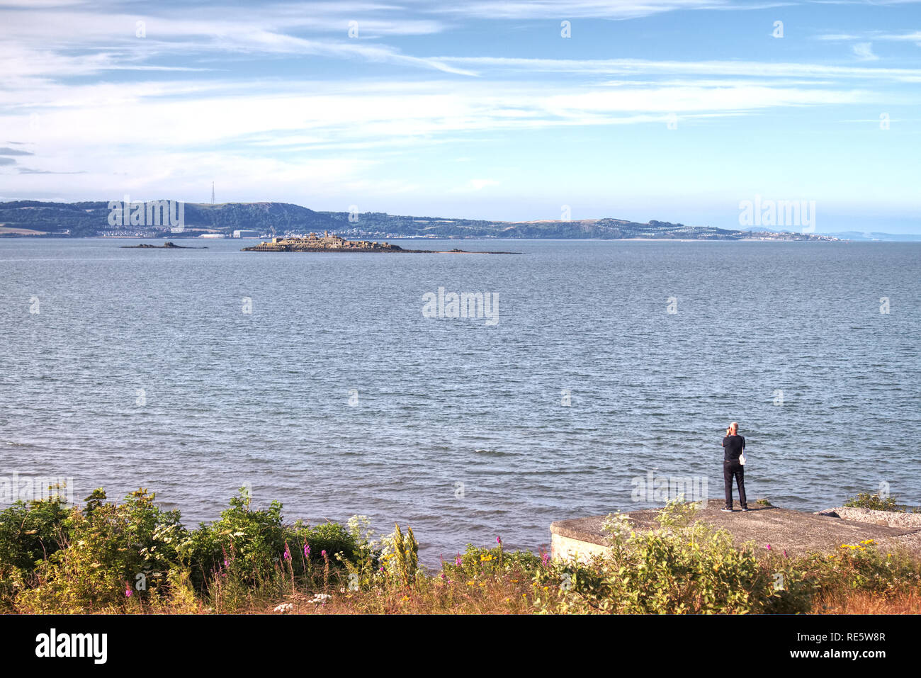 A picture of a lone man taking a photograph of the now deserted island ...