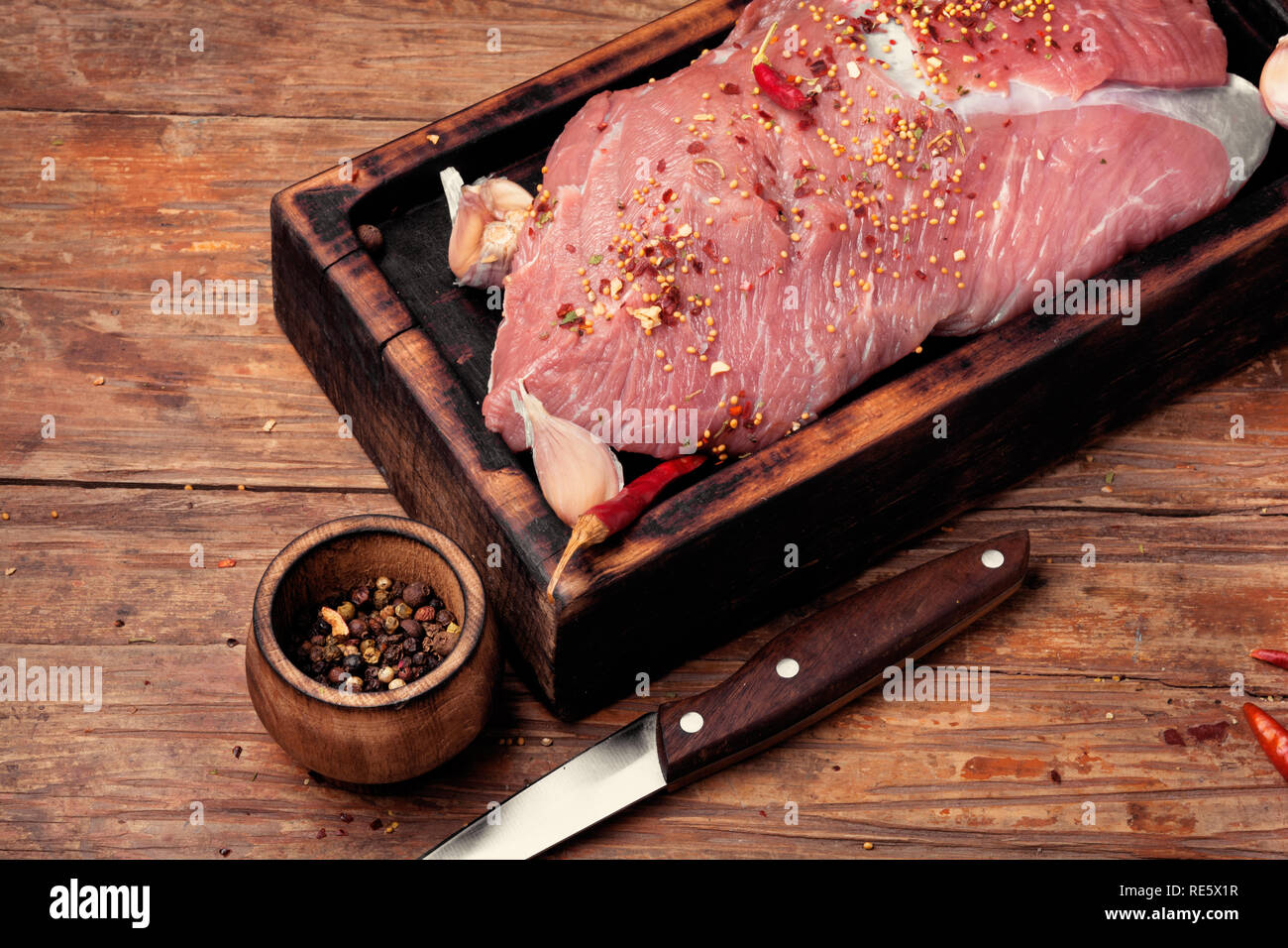 Fresh cut of beef meat on cutting board with spices Stock Photo - Alamy