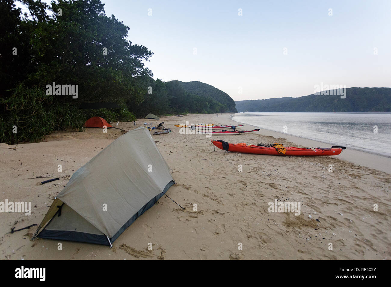 camping on a remote beach while sea kayaking at iriomote island, japan ...