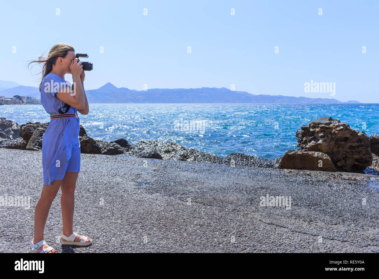 Woman photographer Nature photographer shooting the sea. Travel Concept ...