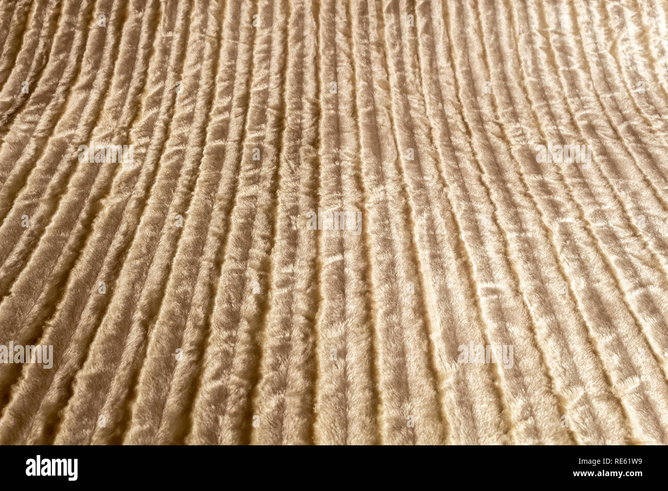 Gentle, soft, beige bedspread on a double bed Stock Photo - Alamy
