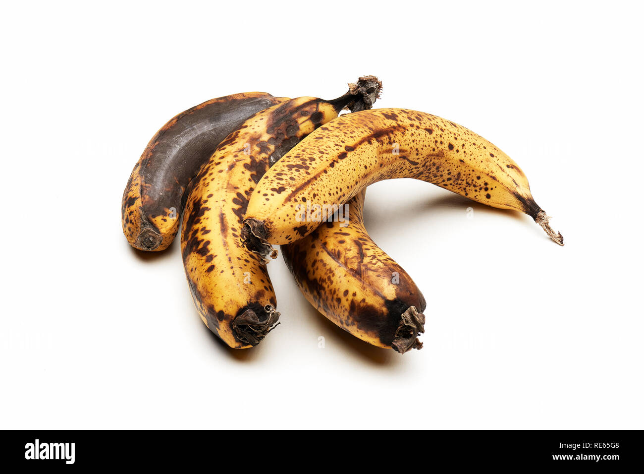 A bunch of bananas beginning to spoil isolated on white background ...