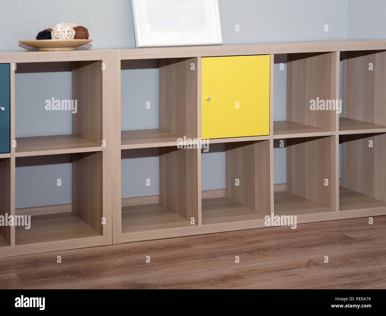 A modern room with empty wooden bookshelf placed on the wooden floor ...