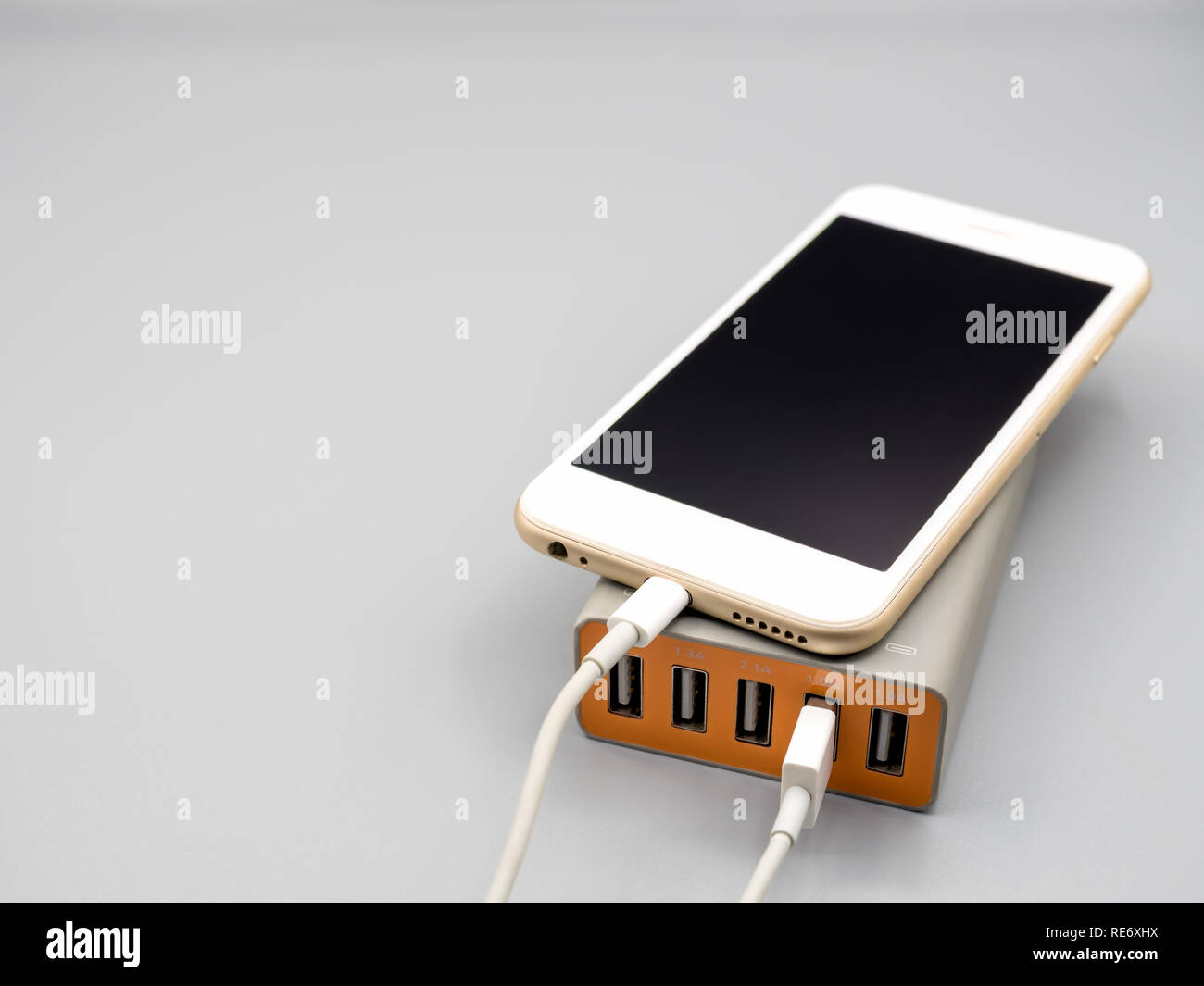 Smart phone charging with multiport USB power adaptor on gray ...