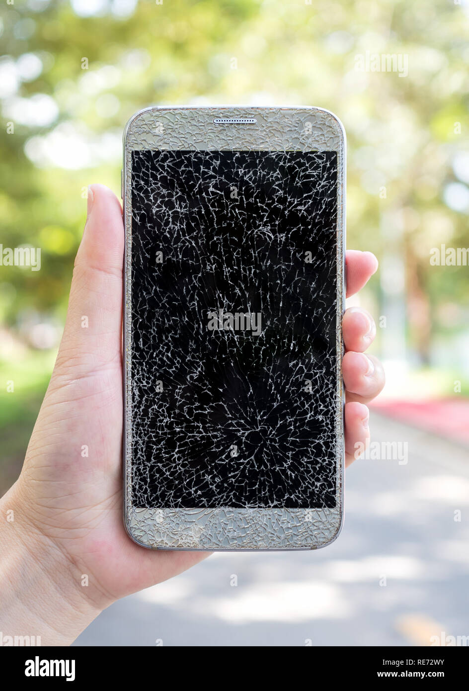 Close-up image of human hand holding old broken and cracked screen ...