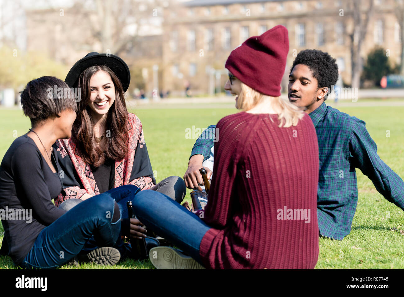 Multi ethnic friends enjoying in the park Stock Photo - Alamy