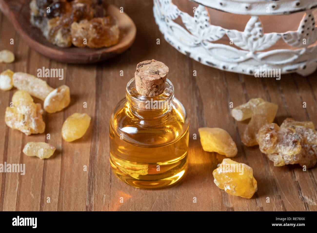 A bottle of essential oil with frankincense resin crystals Stock Photo ...