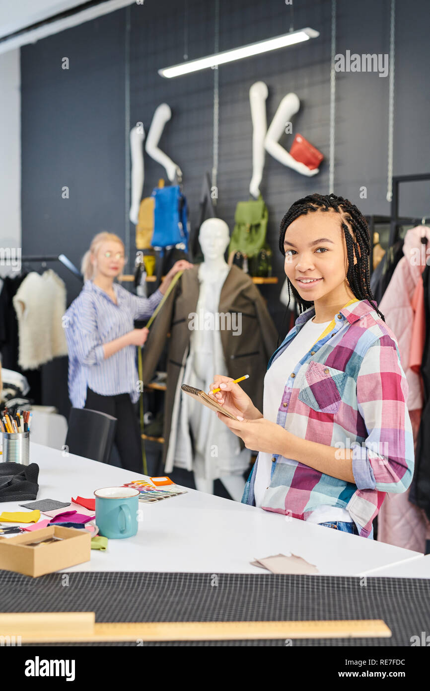 Fashion designers team working in clothes design studio together, woman ...