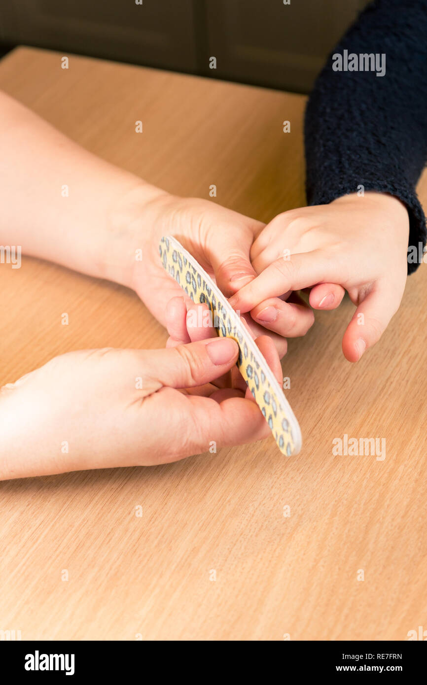 Young woman filing fingernails hi-res stock photography and images - Alamy