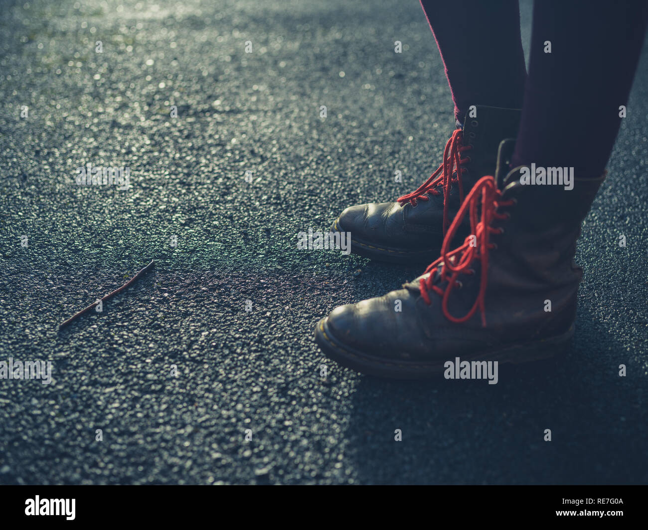 The feet and boots of a person standing next to a worm Stock Photo - Alamy