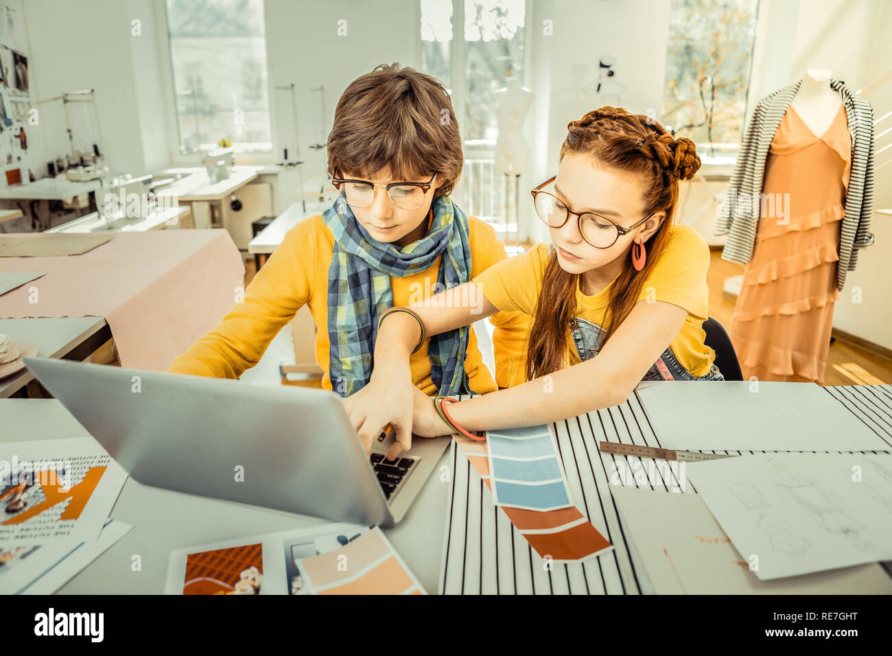 Children of fashion designer designing clothes for summer collection ...